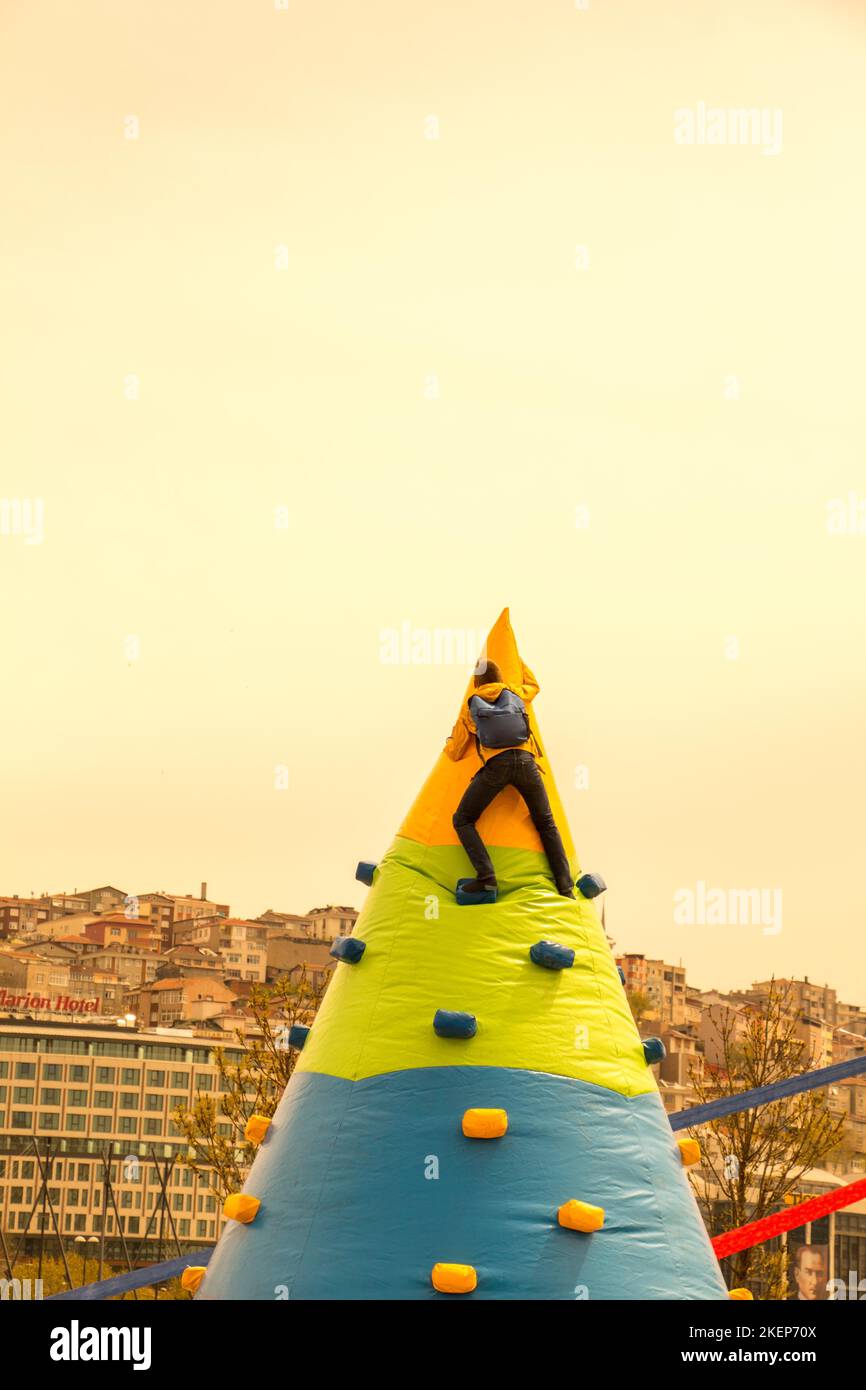 A boy climbing on cone shaped climbing course Stock Photo - Alamy