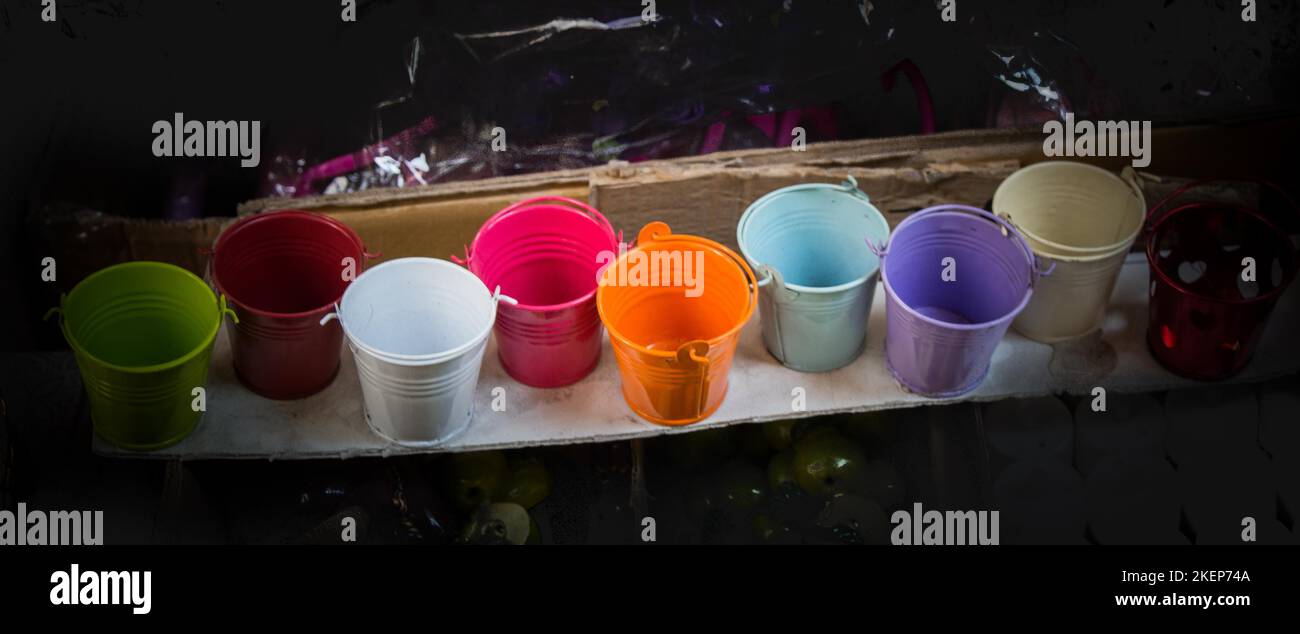 Little set of buckets of various colors in a market place Stock Photo ...