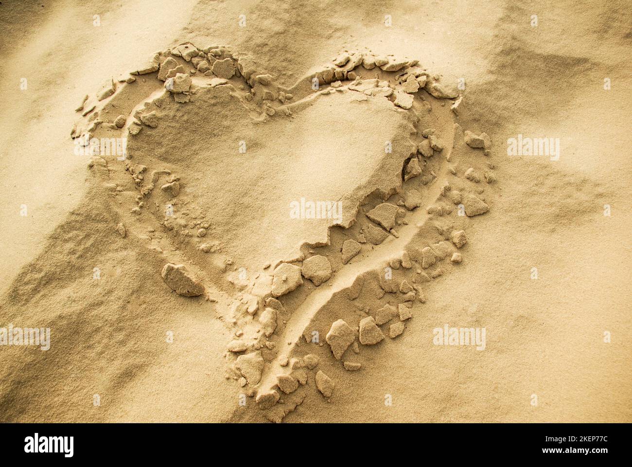Heart shape drawn on sand Stock Photo - Alamy