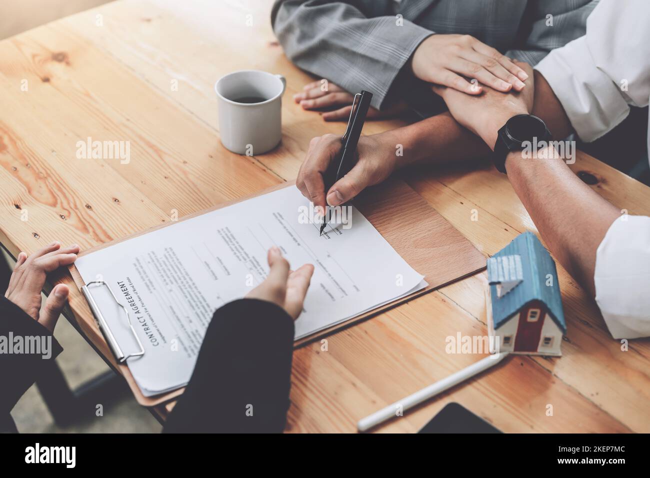 A spouse entering a home contract is reading the terms of the loan ...