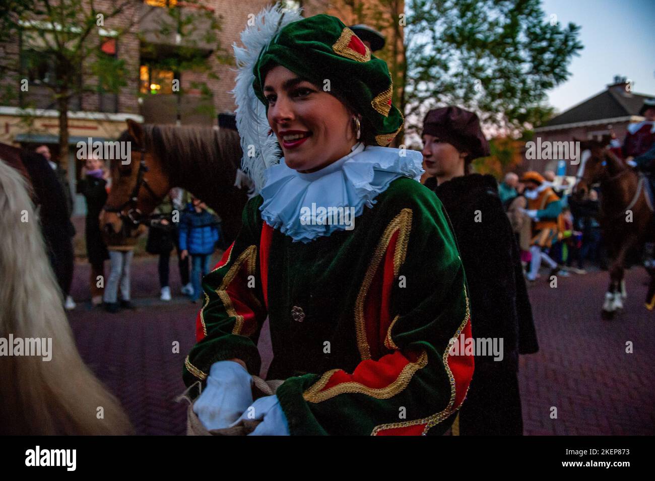A female St Nicholas' helper is seen carrying sweets to give to the ...