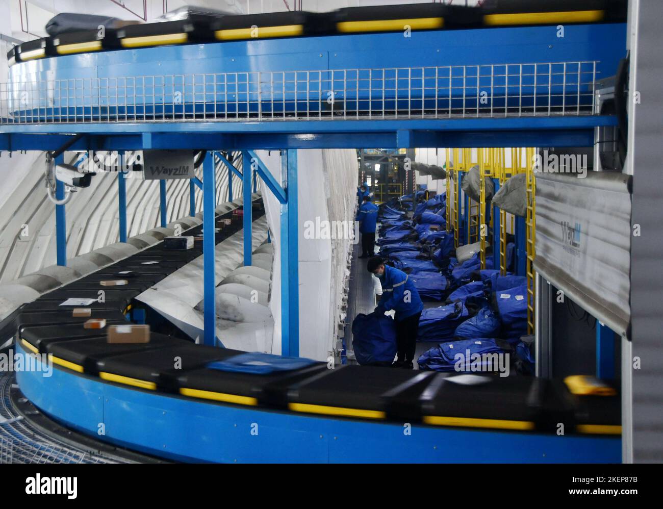 Workers are sorting express parcels at ZTO Express Transfer Center in ...