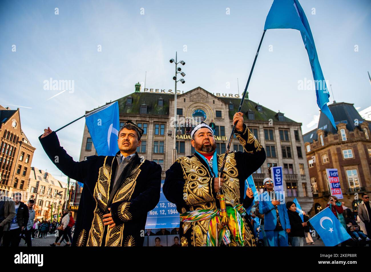Two Uyghur men raise East Turkistan flags as the Uyghur national anthem ...
