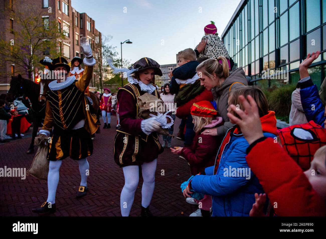St Nicholas' helpers are seen giving cookies to the children. The first ...