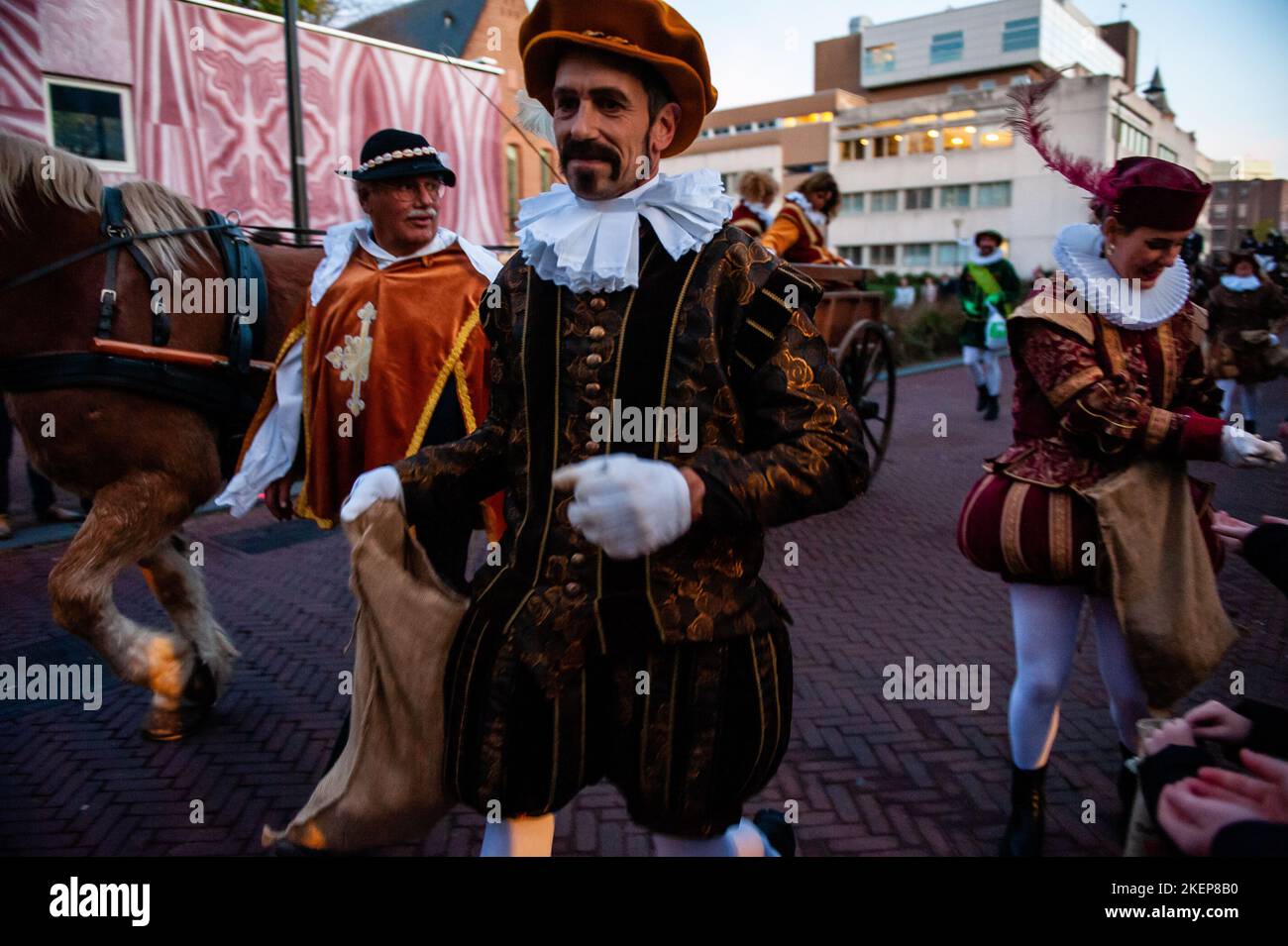 St Nicholas’ helpers are seen giving sweets to the children. The first ...