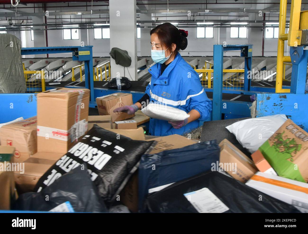 Workers are sorting express parcels at ZTO Express Transfer Center in ...