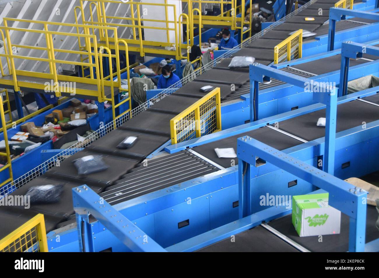 Workers are sorting express parcels at ZTO Express Transfer Center in ...