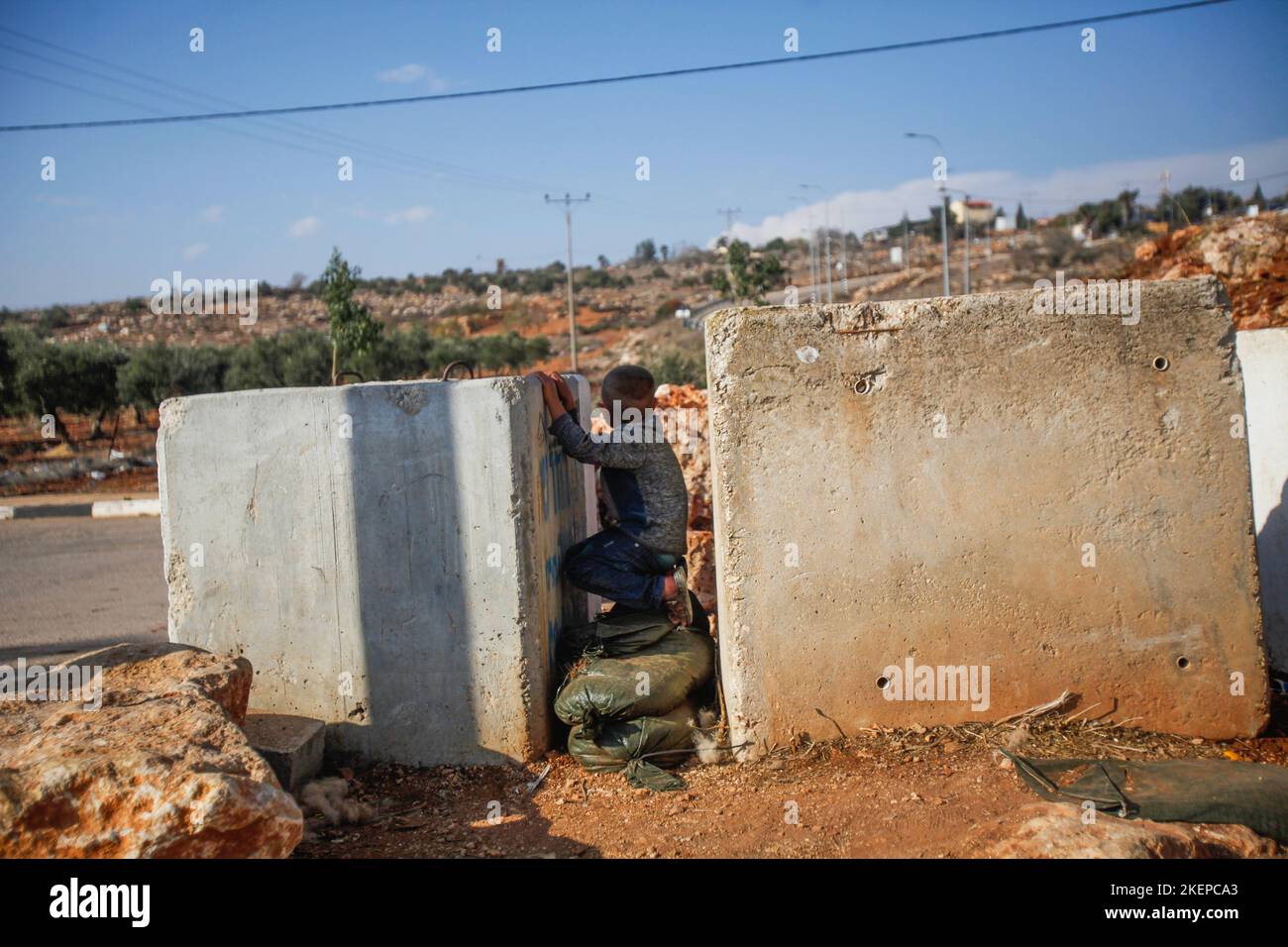 Nablus, Palestine. 13th Nov, 2022. A Palestinian child tries to cross ...