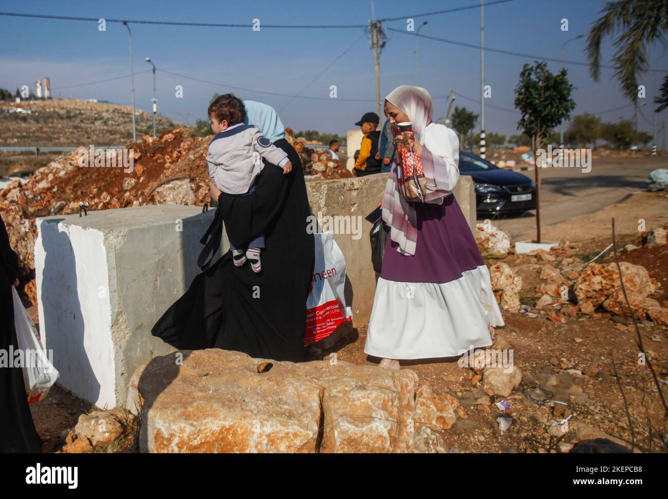 Palestinian women cross the earth mounds that were set as blockades by ...