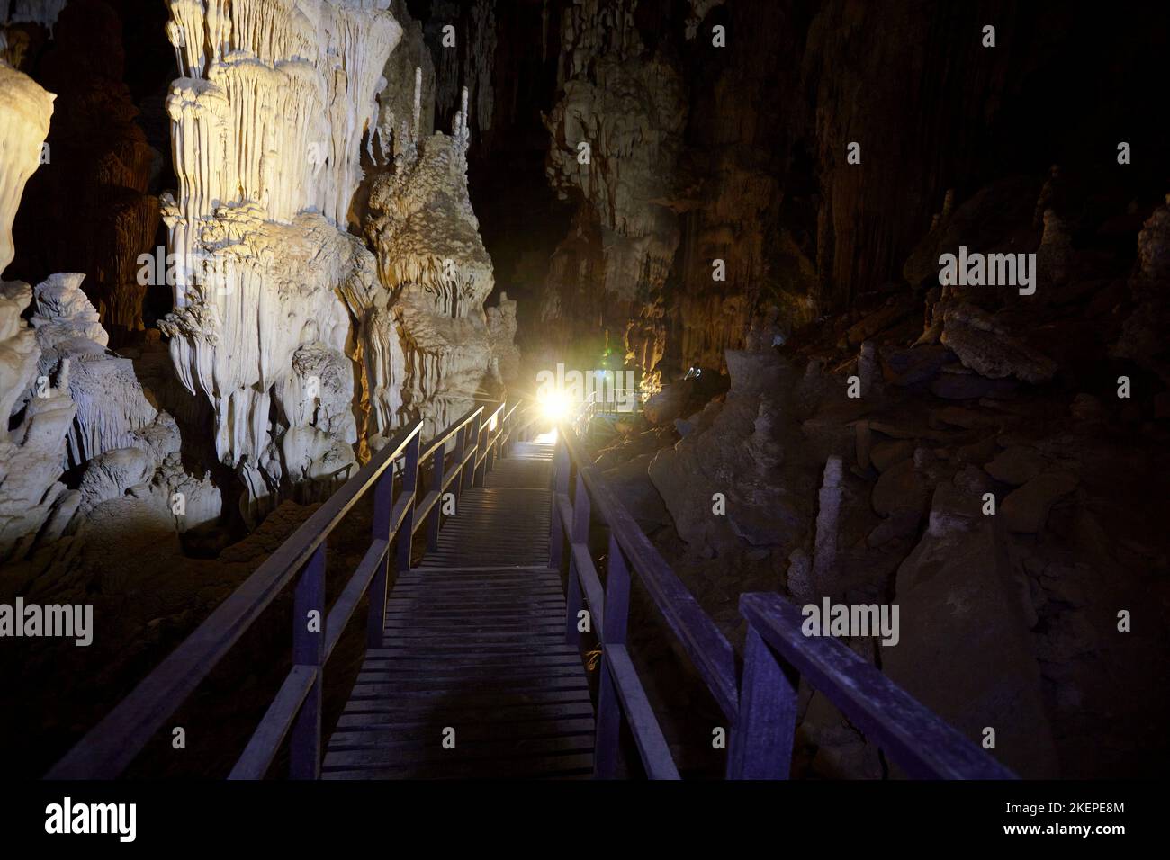 Stalactite and stalagmite with the wooden walking path along in Phu Pha ...