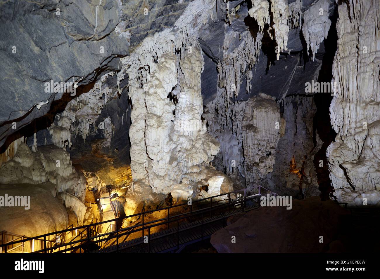 Stalactite and stalagmite with the wooden walking path along in Phu Pha ...