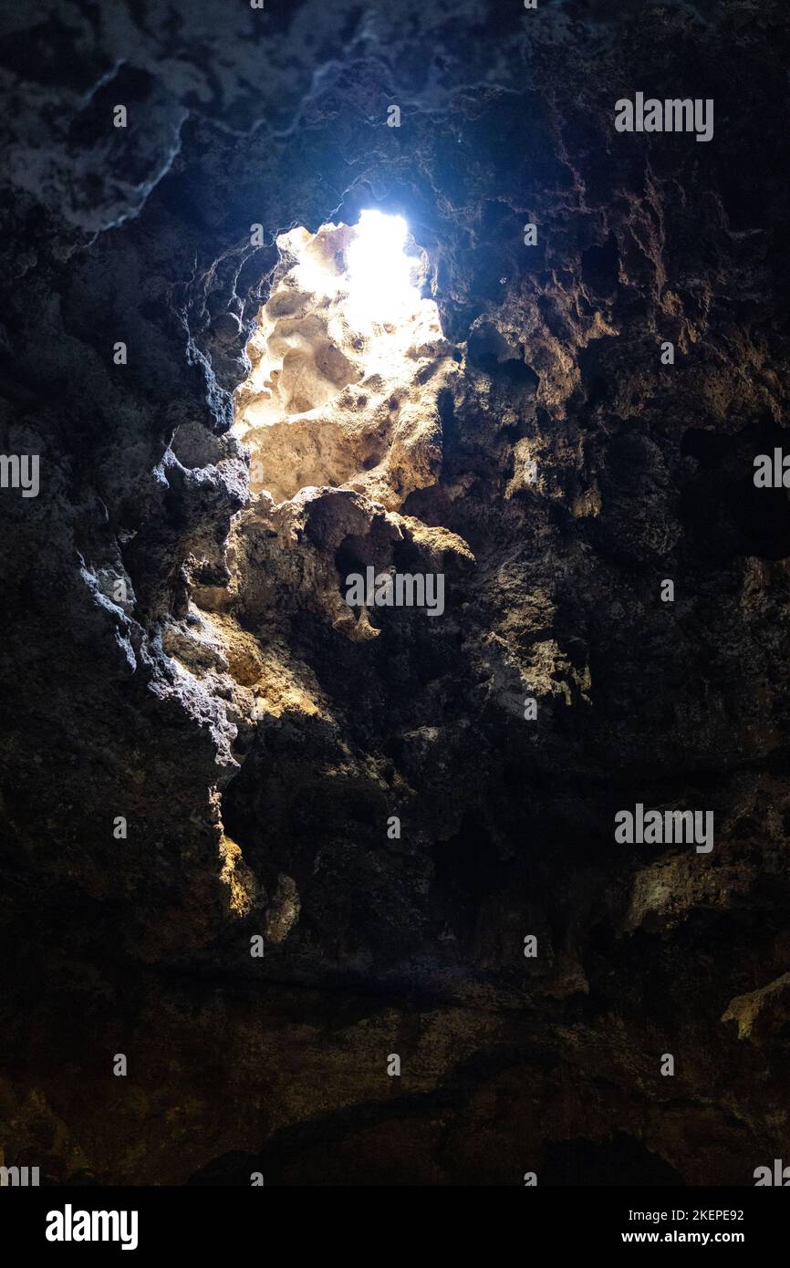 sun light coming through an opening in the roof of a cave Stock Photo ...