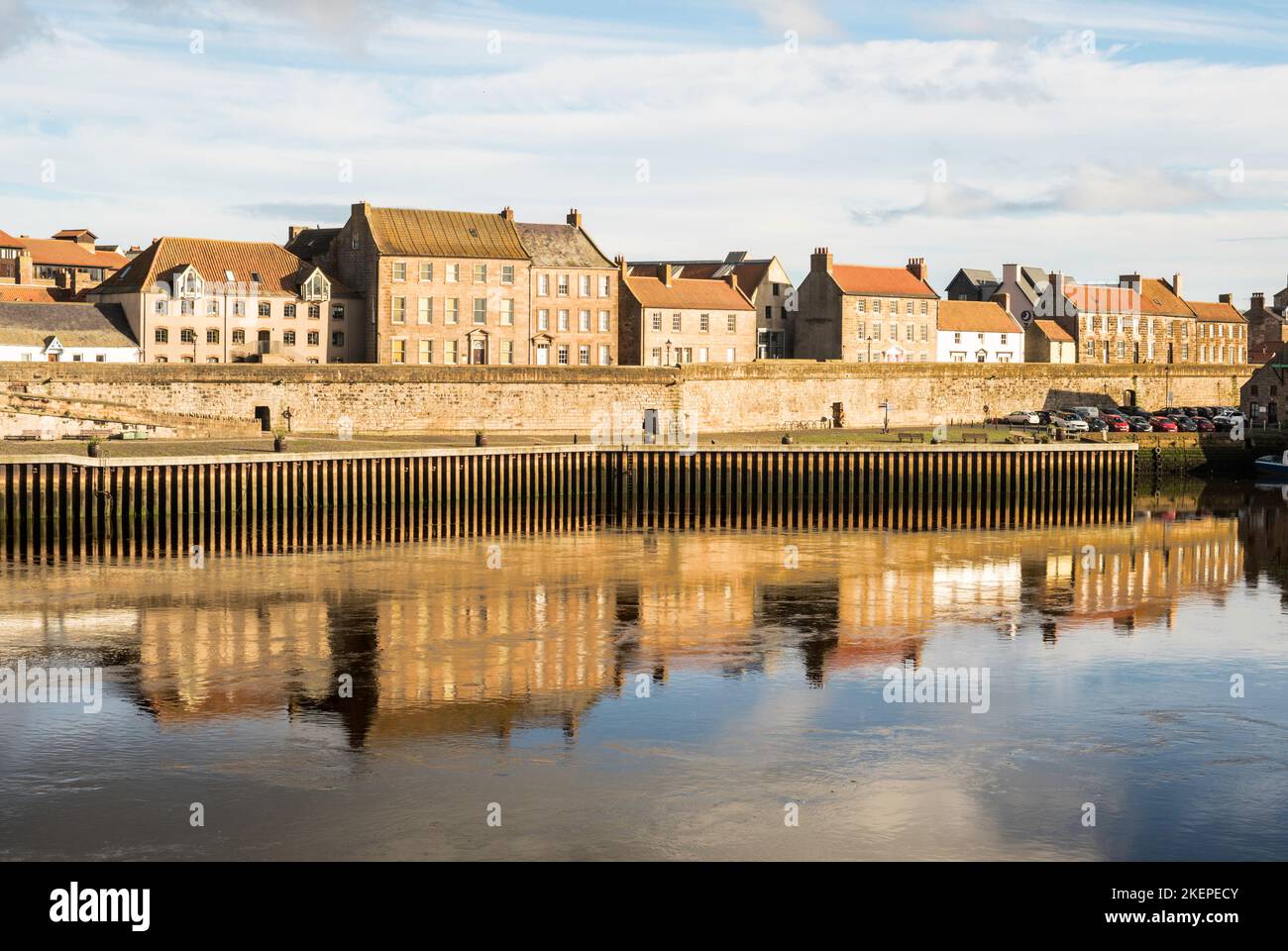 Buildings and town walls reflected in the river Tweed, in Berwick upon ...