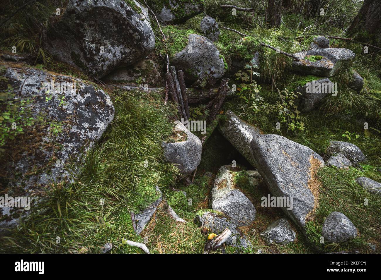Wide-angle shot of the timber-fortified cave entrance on a mountain ...