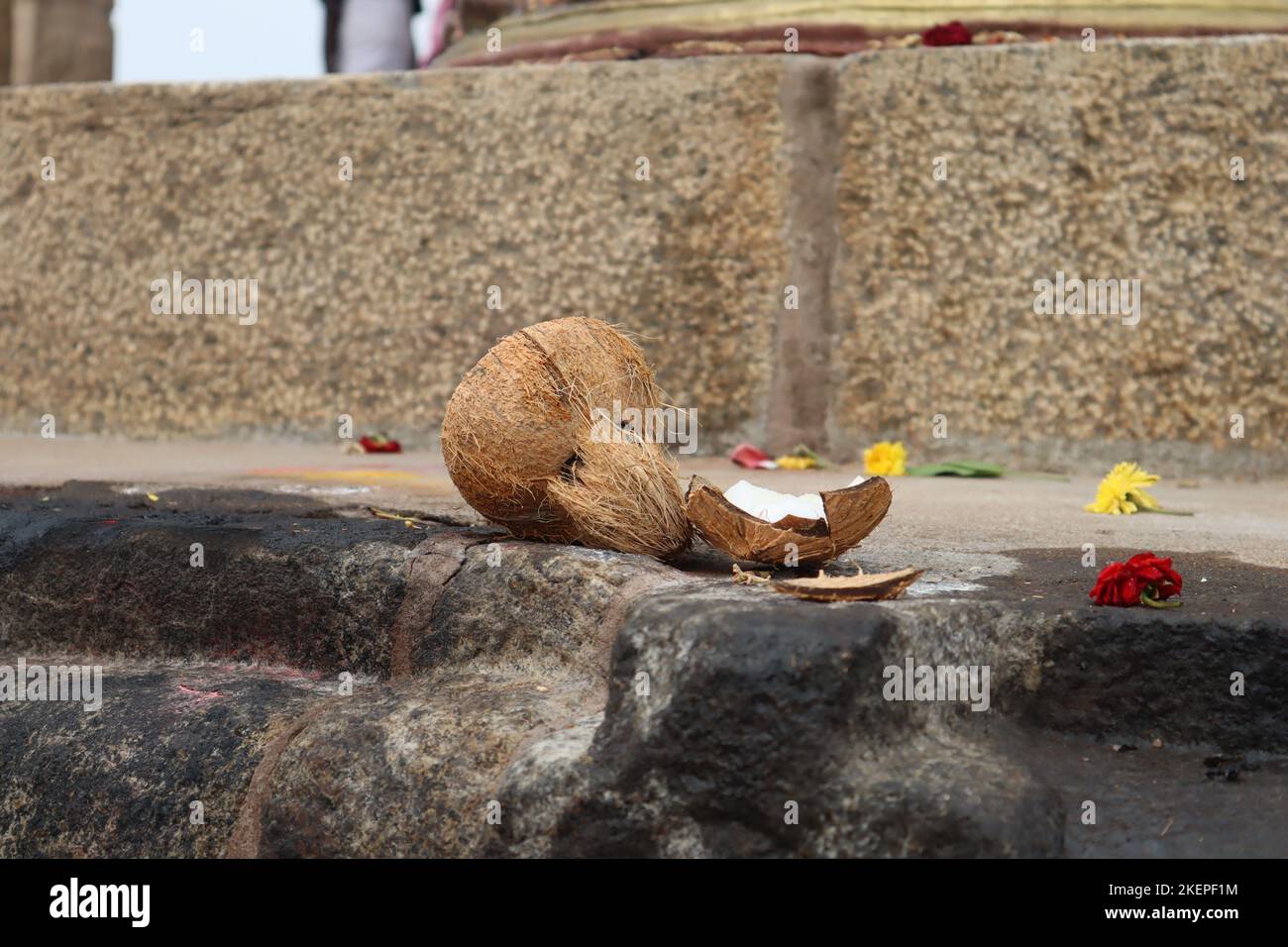 A broken coconut submitted to God in prayer Stock Photo - Alamy