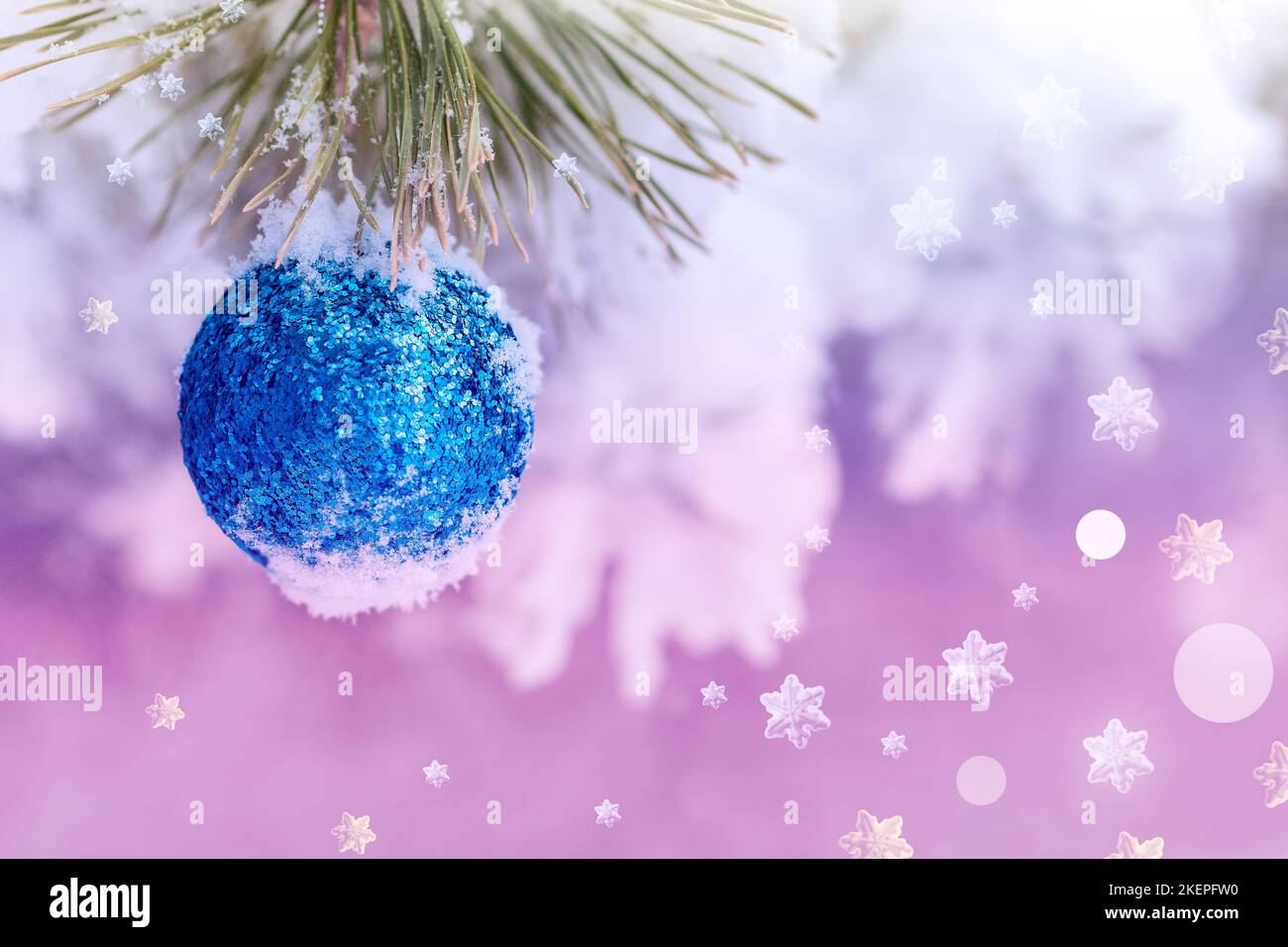 Christmas blue ball in the snow on a pine branch.Christmas background ...