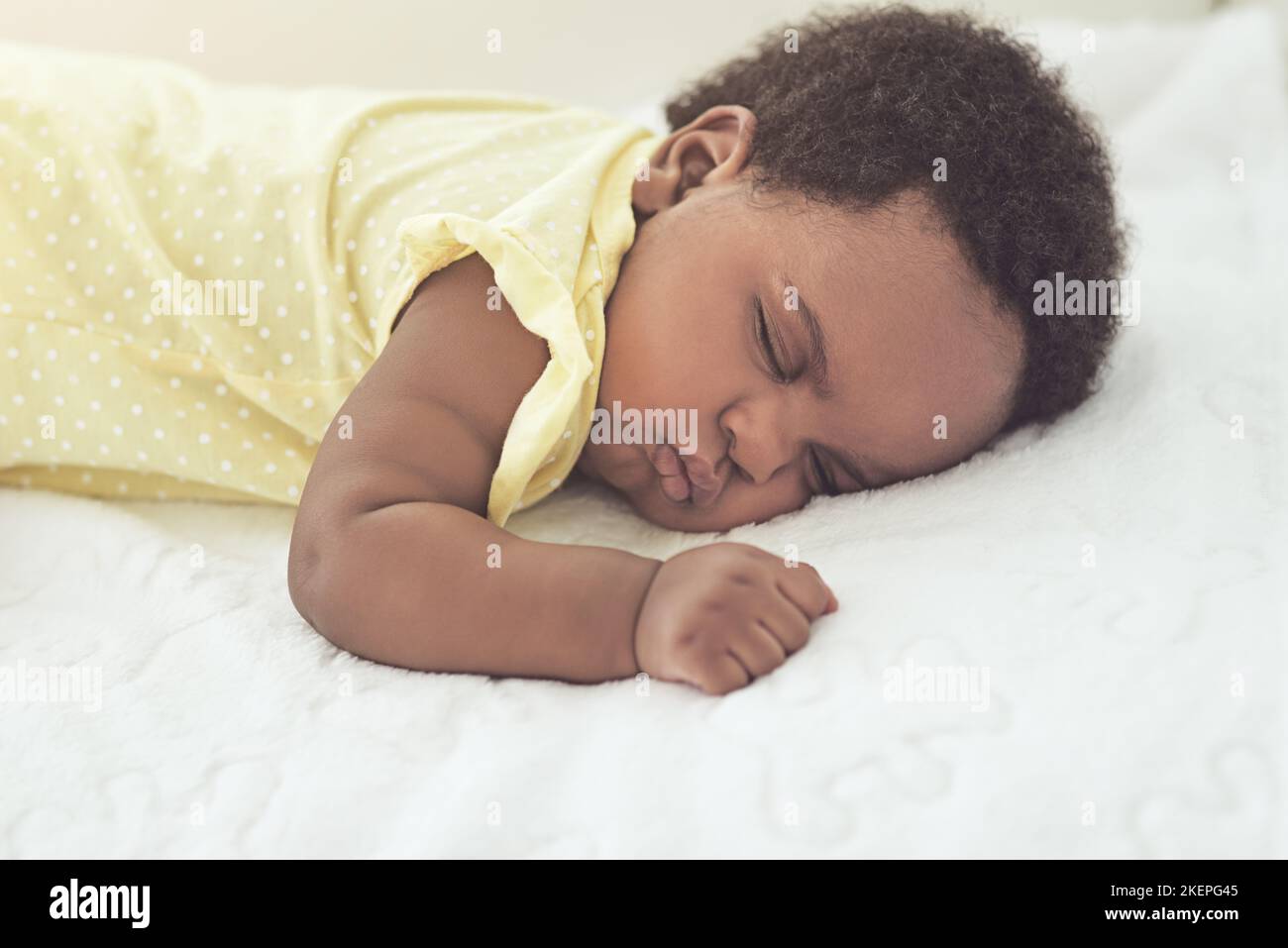 Growing while she sleeps. a baby girl asleep on a bed at home Stock ...