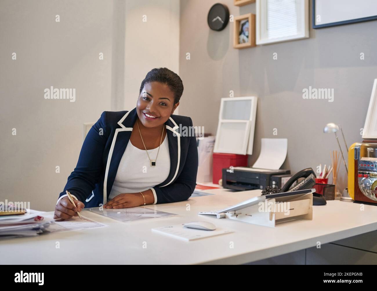 She gets the job done with a smile. Portrait of a businesswoman sitting ...