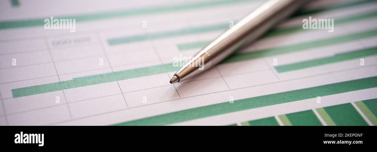 Closeup of analyzed graphs and charts with pen in office Stock Photo ...