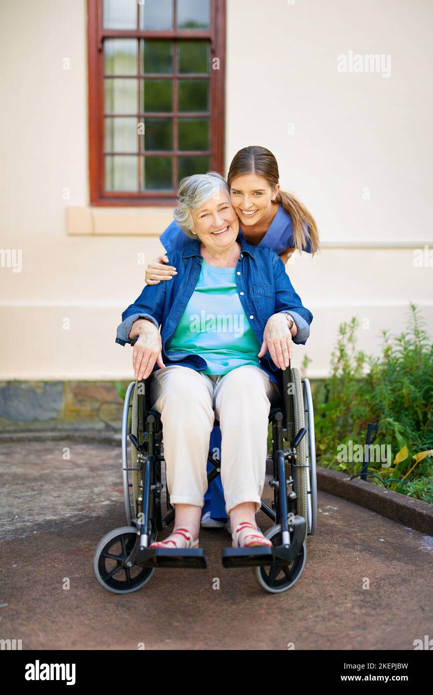 Taking her for a walk though the gardens. a resident and a nurse ...