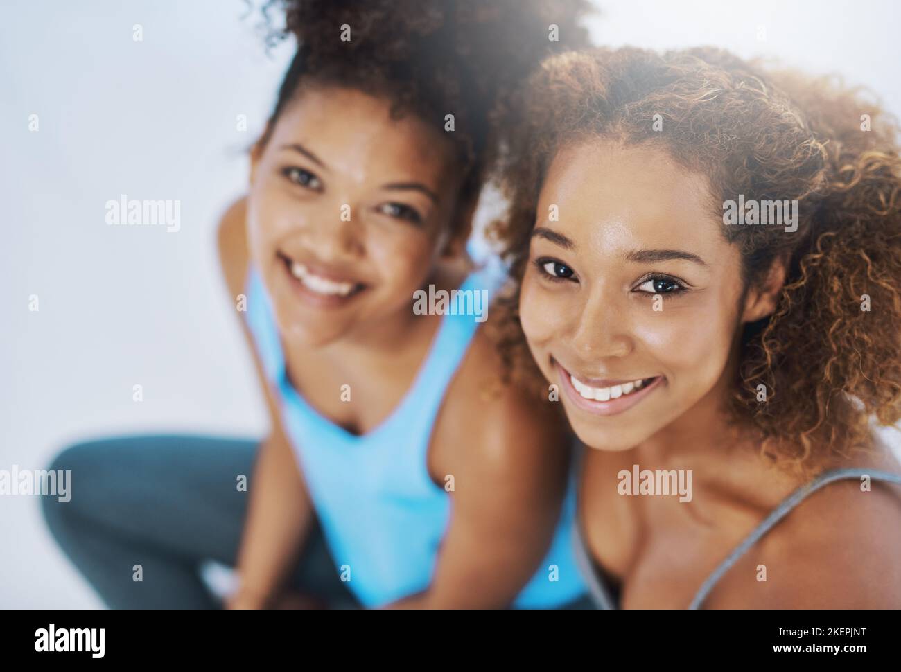 Yoga keeps us looking up. High angle portrait of two young women after ...