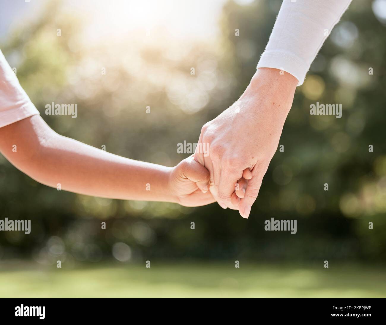 Park, family and parent holding hands with child enjoying nature ...