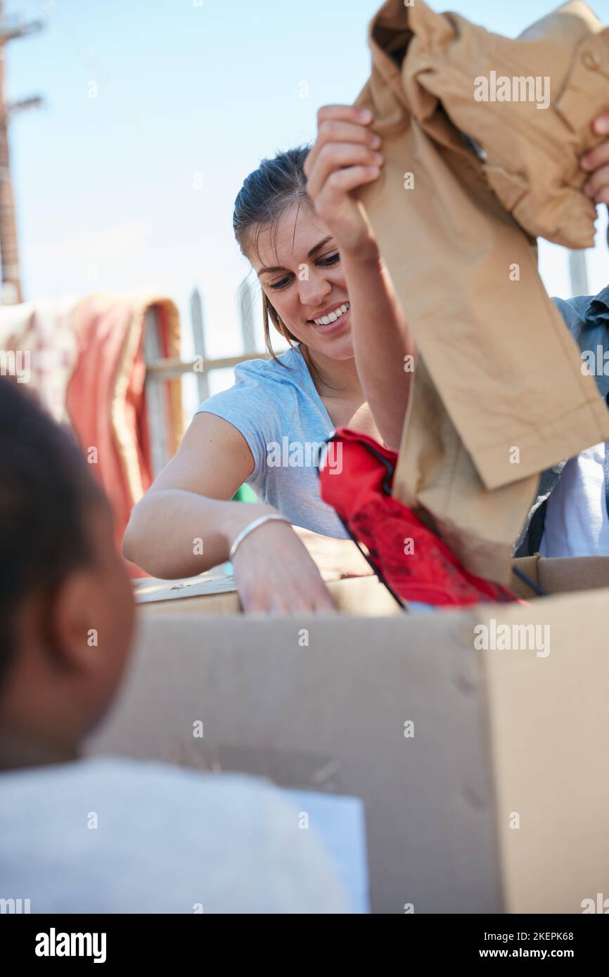Woman sorting clothes out hi-res stock photography and images - Alamy