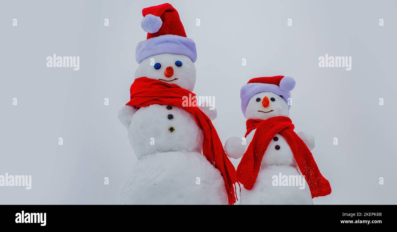 Funny Snowmen. Two snowman on snow background Stock Photo - Alamy