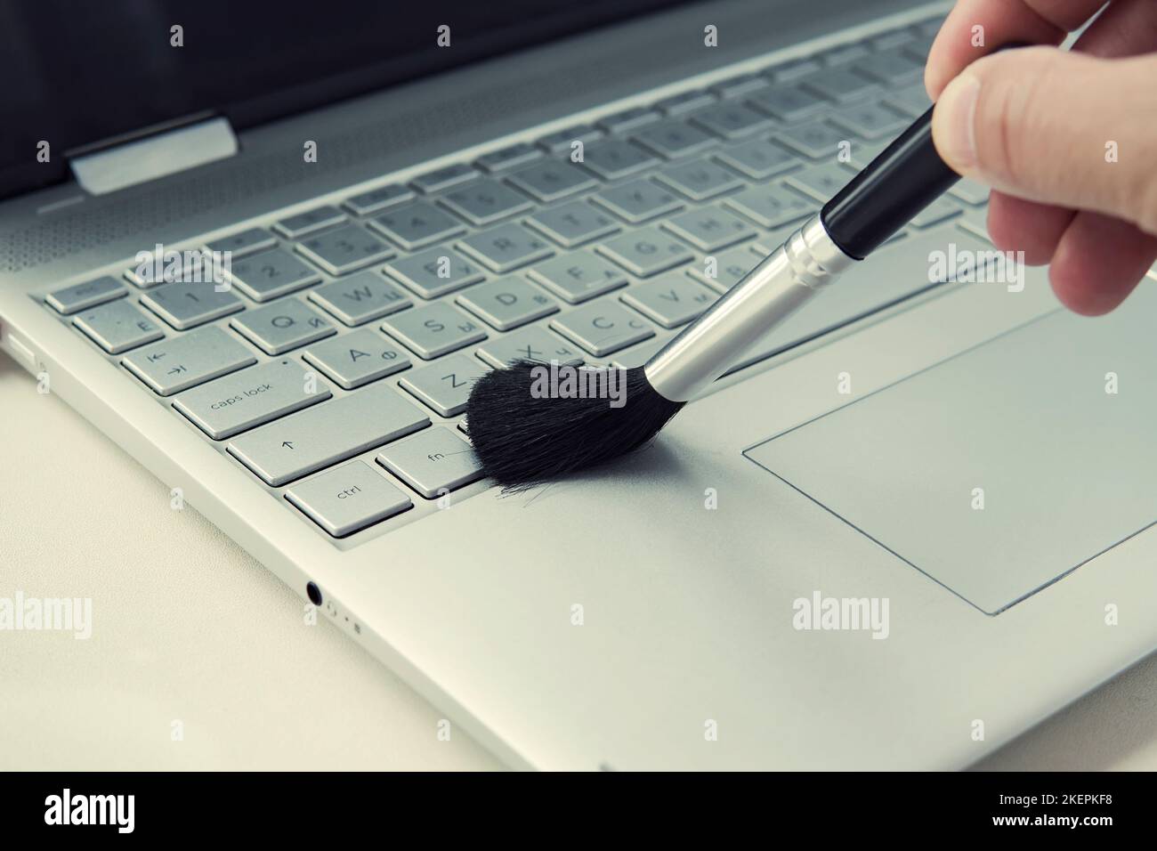 Cleaning Brush and laptop On Office desk wood table. cleaning the ...