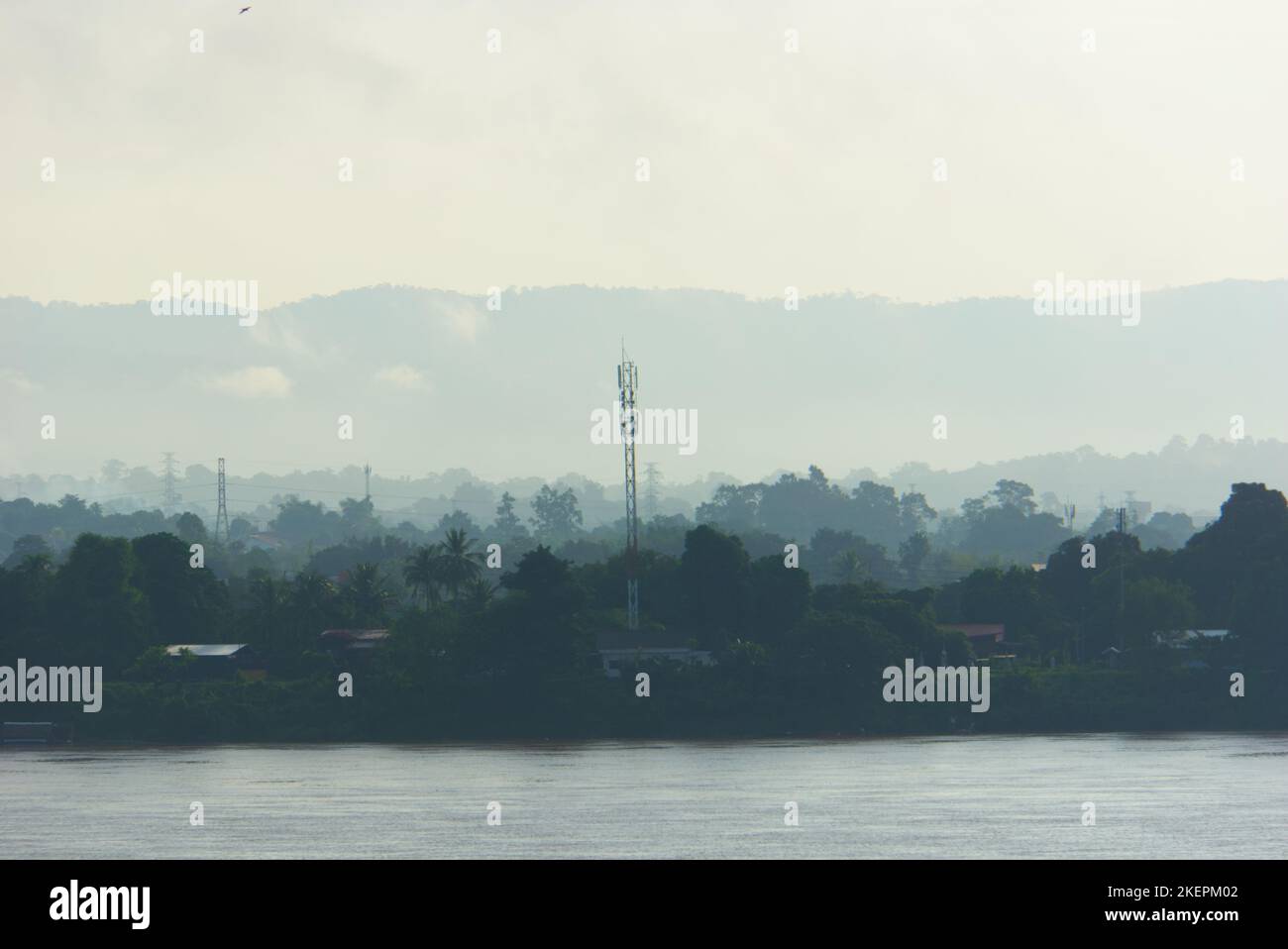 Mekong river landscape with buildings, infrastructure, cell phone pylon ...