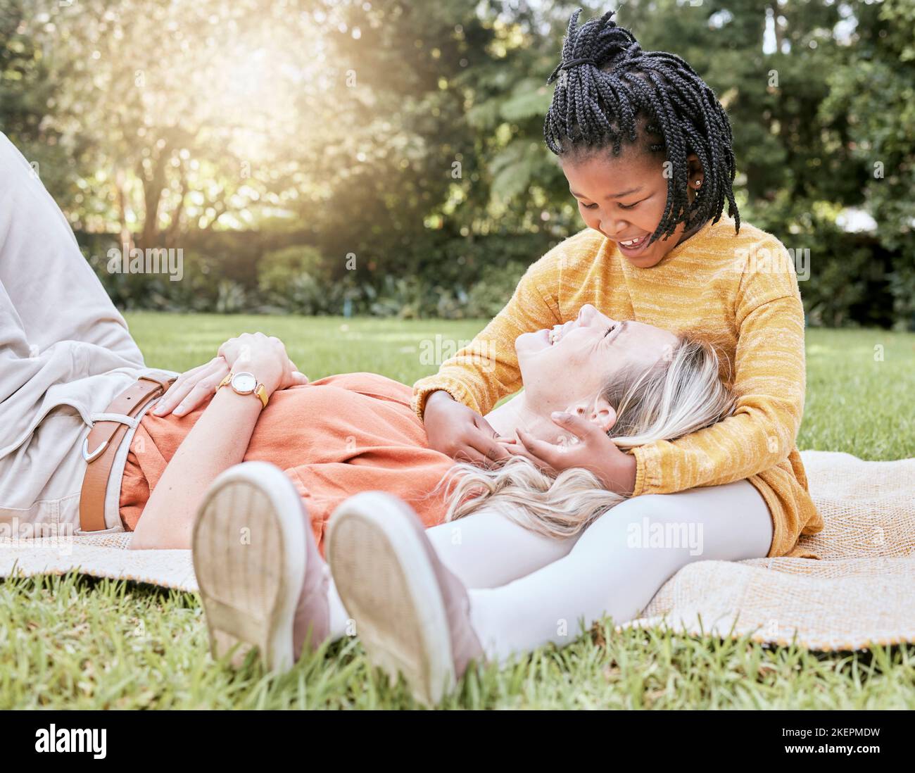 Mother, picnic and happy child in a interracial family with a smile ...