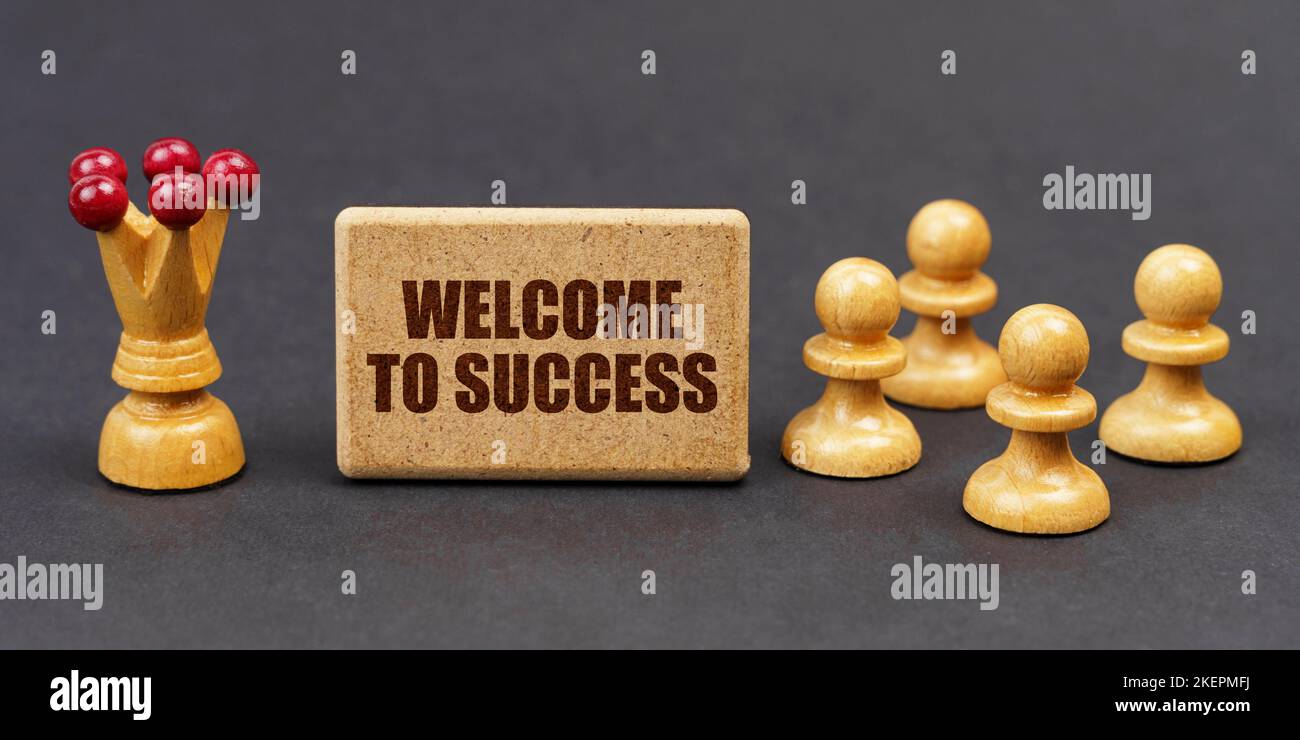 Business concept. On a black background, chess and a sign with the ...