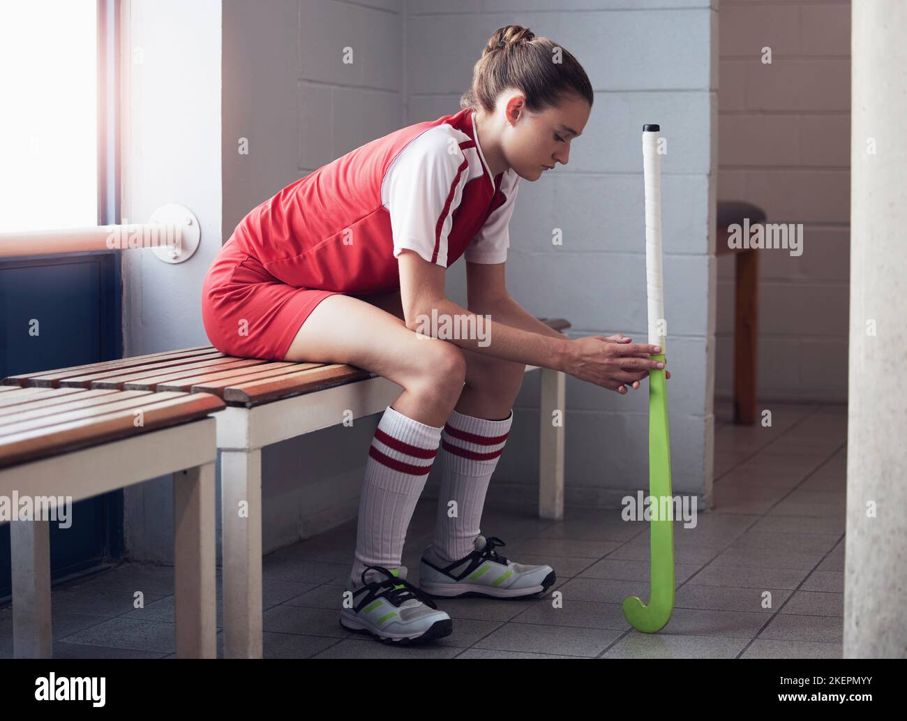 Hockey, sports and defeat with a woman athlete on a bench in the locker ...