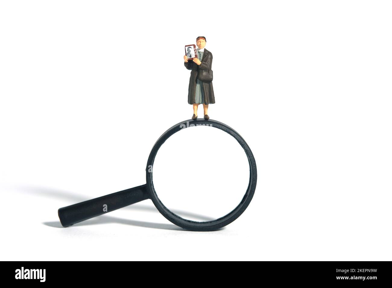 Miniature people toy figure photography. A woman holding photo frame ...