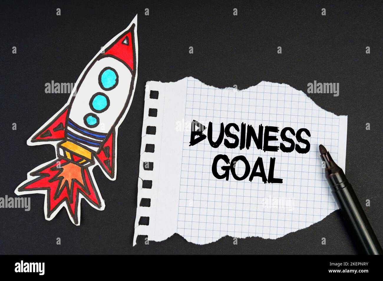 Business and finance concept. On a black background, a rocket, a marker ...
