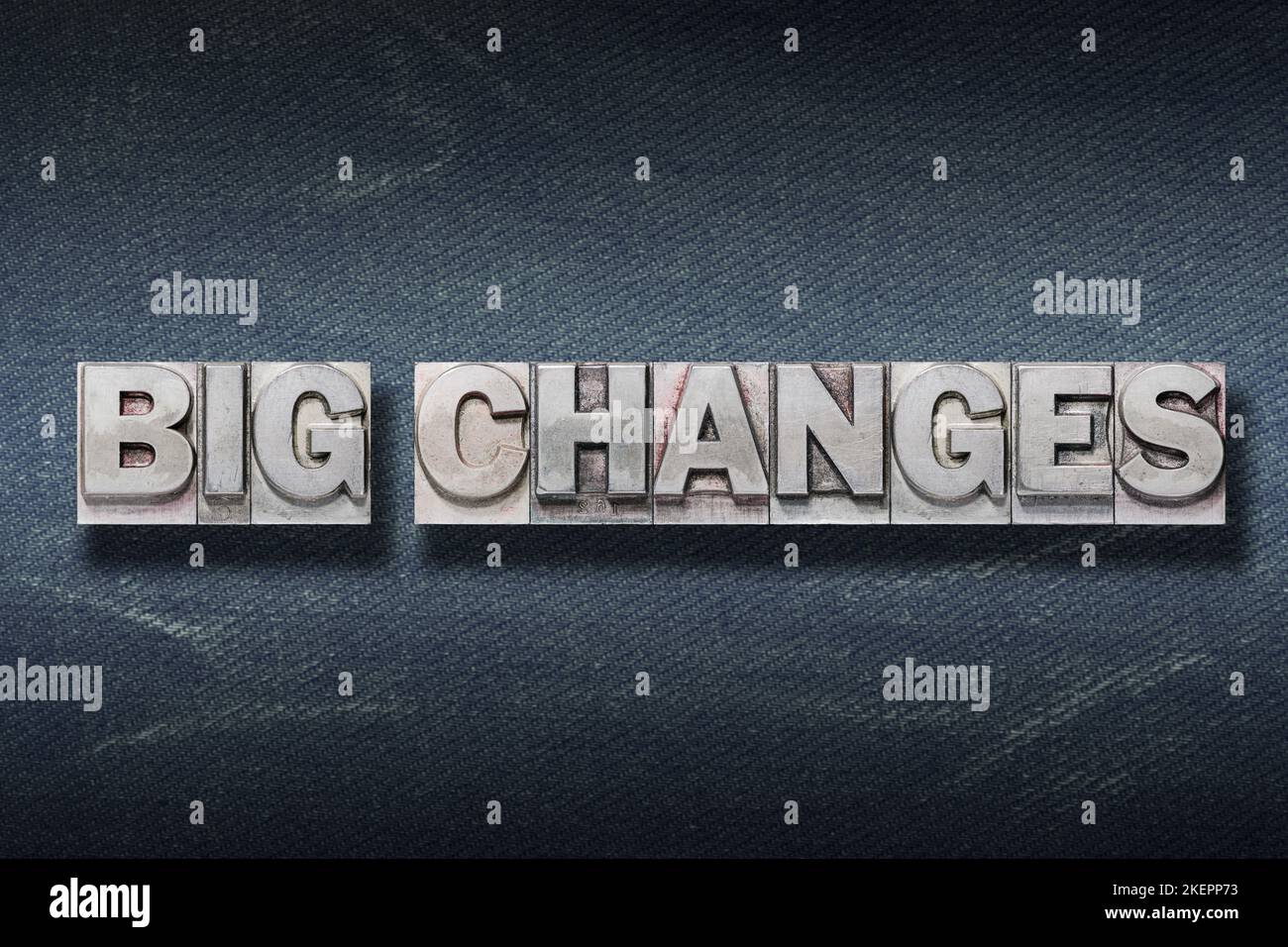 big changes phrase made from metallic letterpress on dark jeans ...