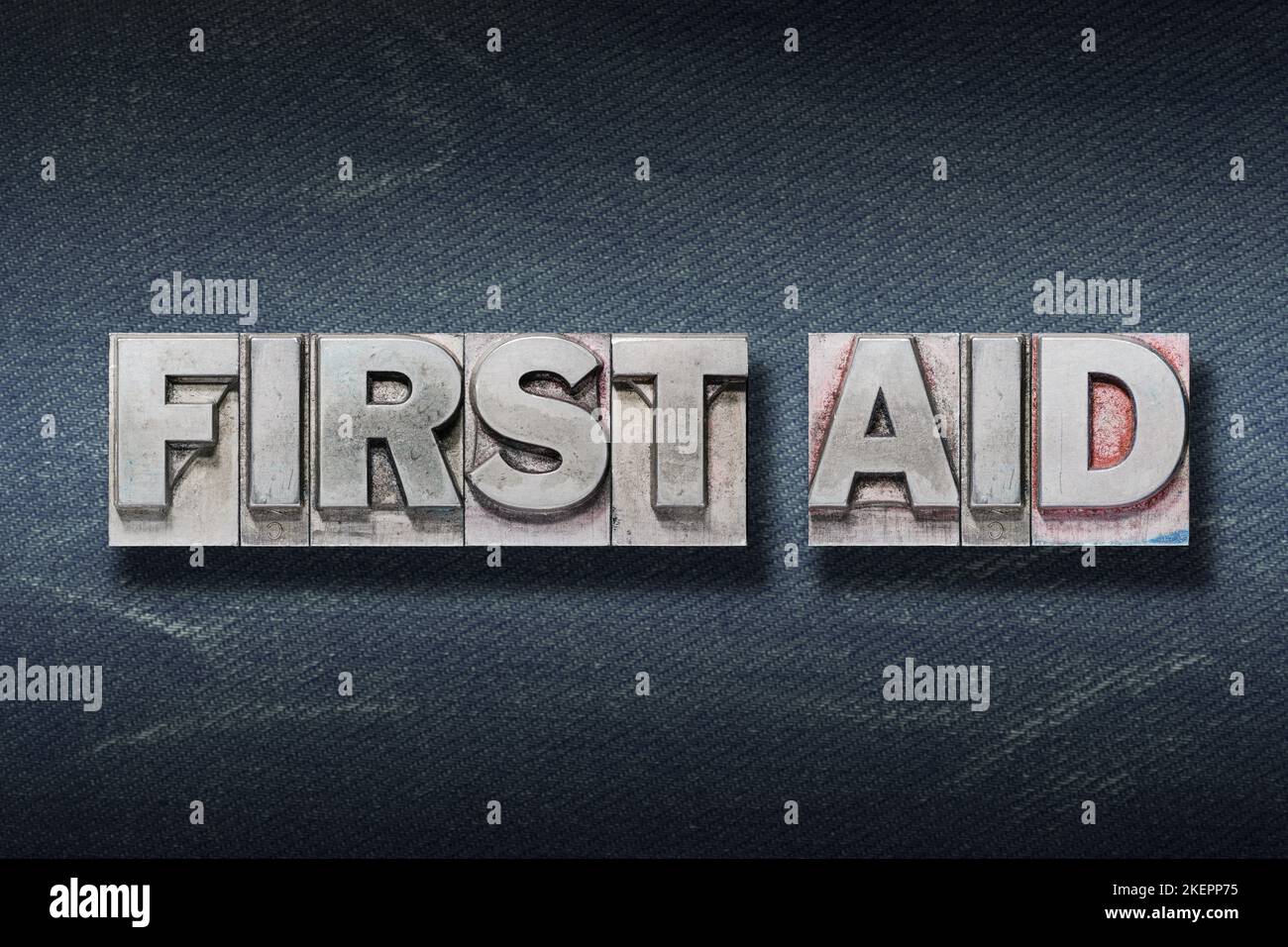 first aid phrase made from metallic letterpress on dark jeans ...