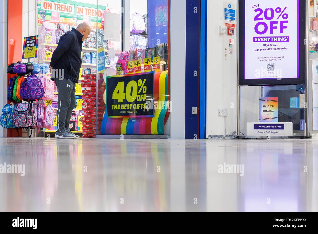 Basingstoke. 13th Nov, 2022. A man stands at the entrance of a store in ...