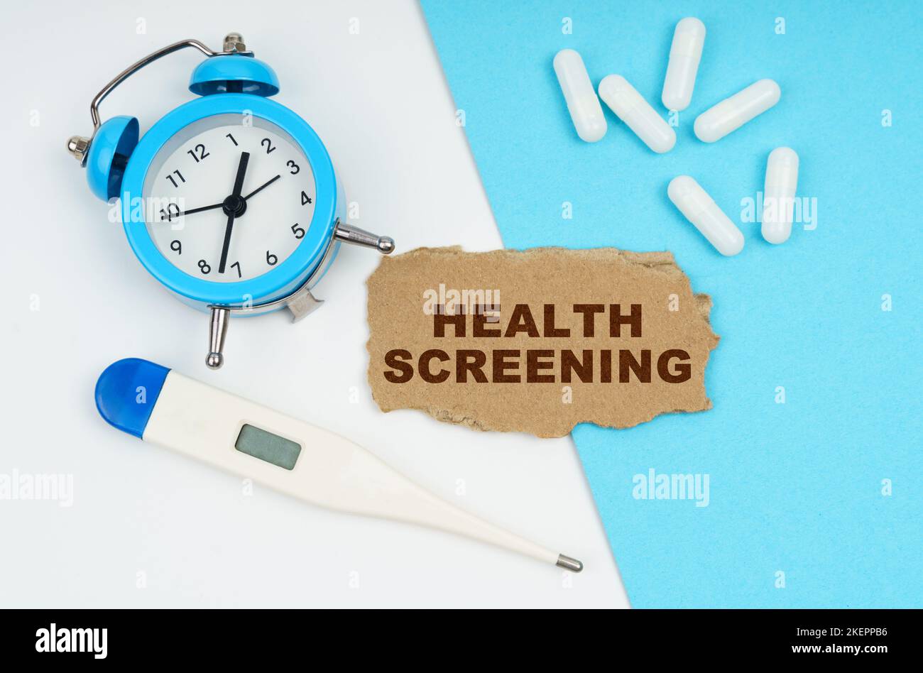 Medical concept. A clock, a thermometer, a syringe and a cardboard with ...