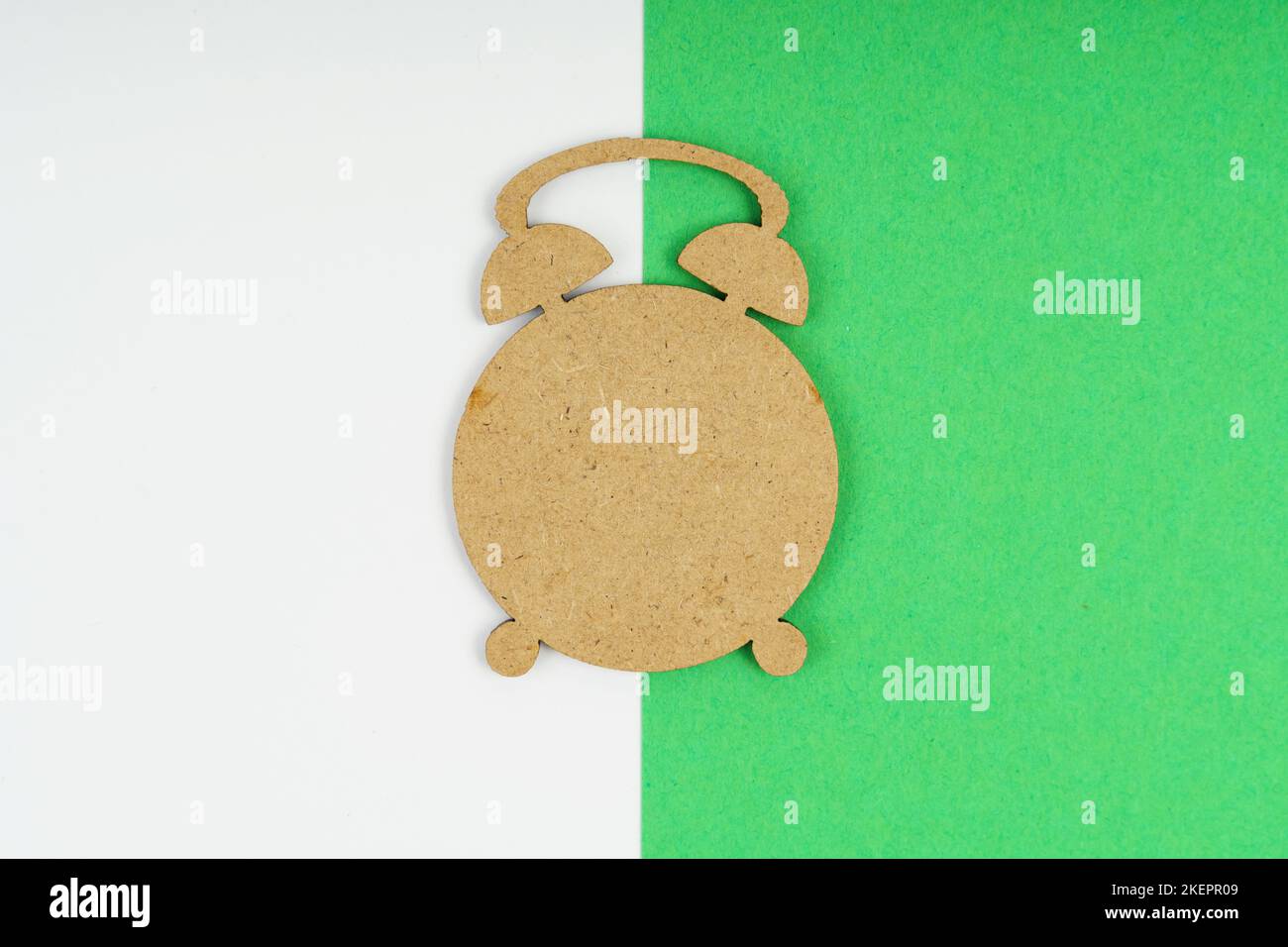 Environmental concept. Wooden clock on a white green background Stock ...