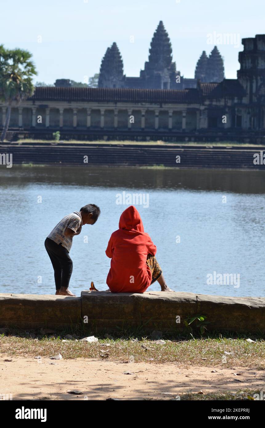 Kids sitting in front of Angkor Wat Cambodia ruin historic khmer temple ...