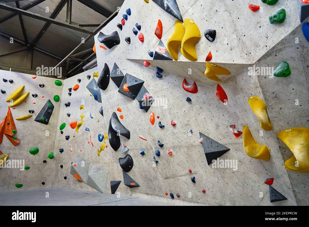Wall for bouldering in gym with holds for climbing. Active extreme ...