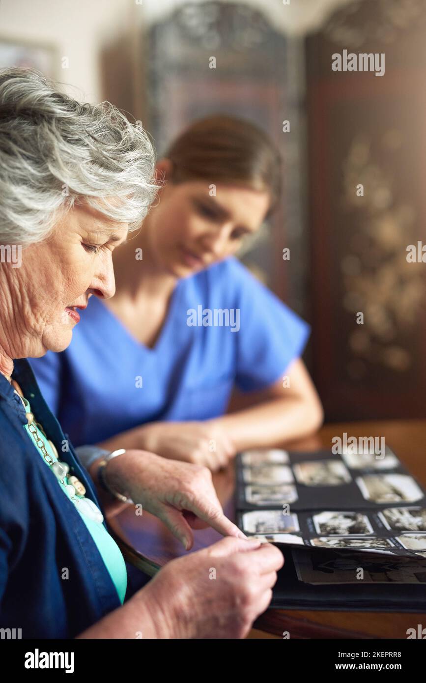 Women looking through photo album hi-res stock photography and images ...