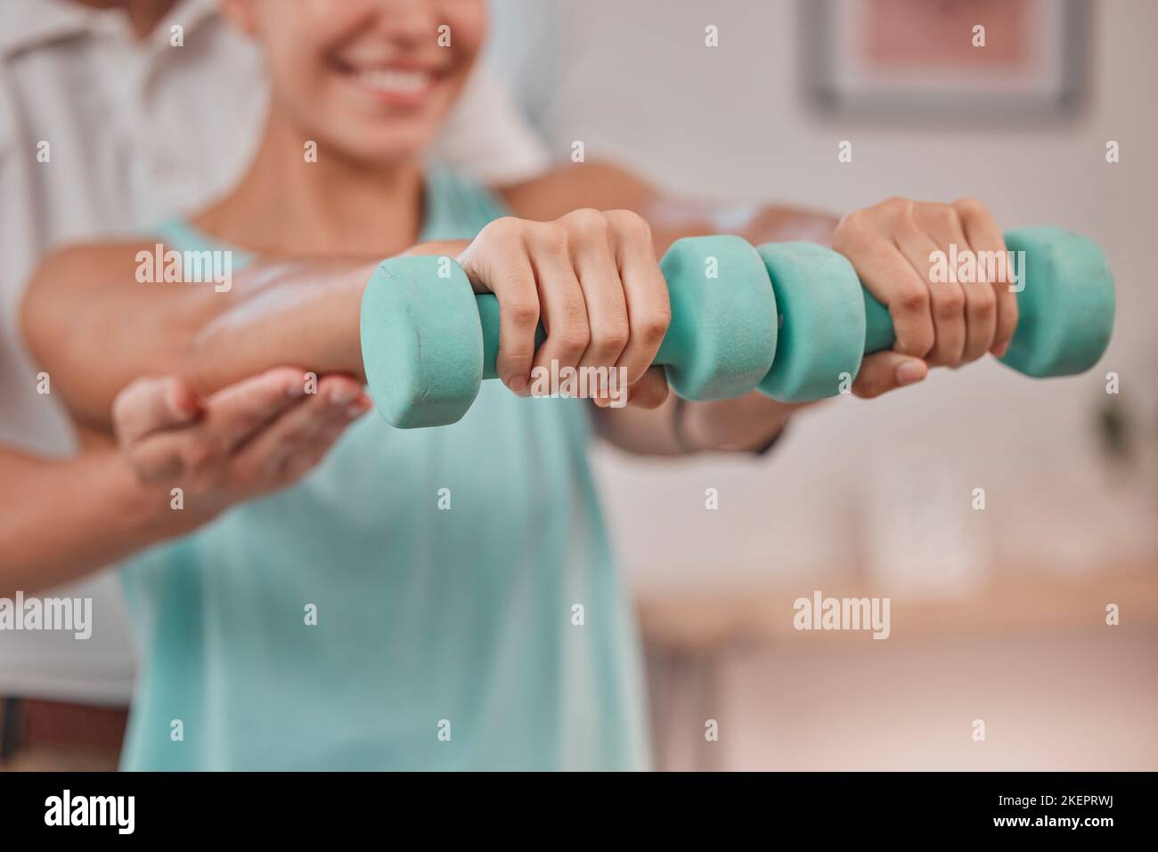 Rehabilitation, physiotherapy and weights of a woman patient in a ...