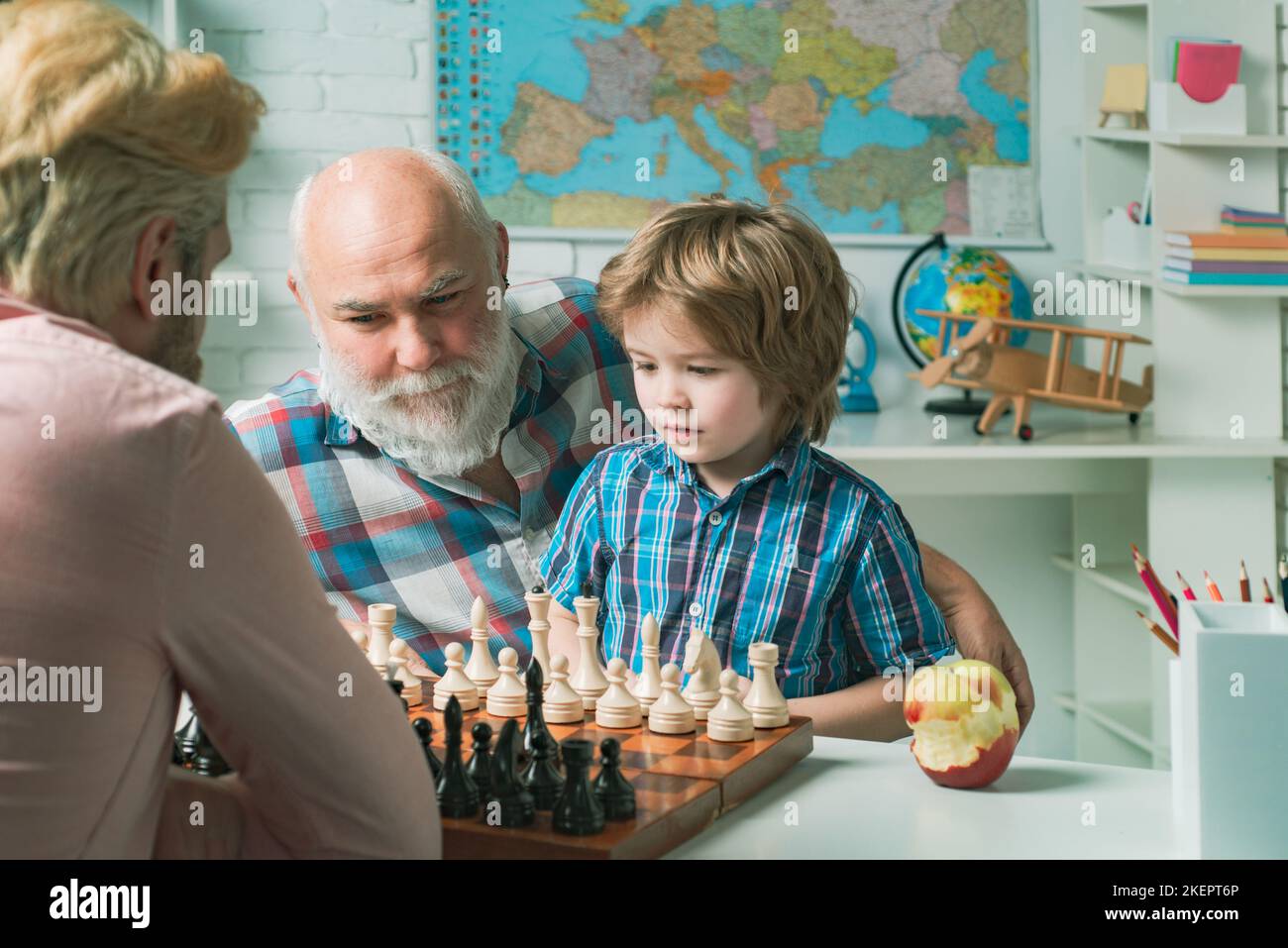 Portrait grandpa and grandson playing chess. Family relationship ...