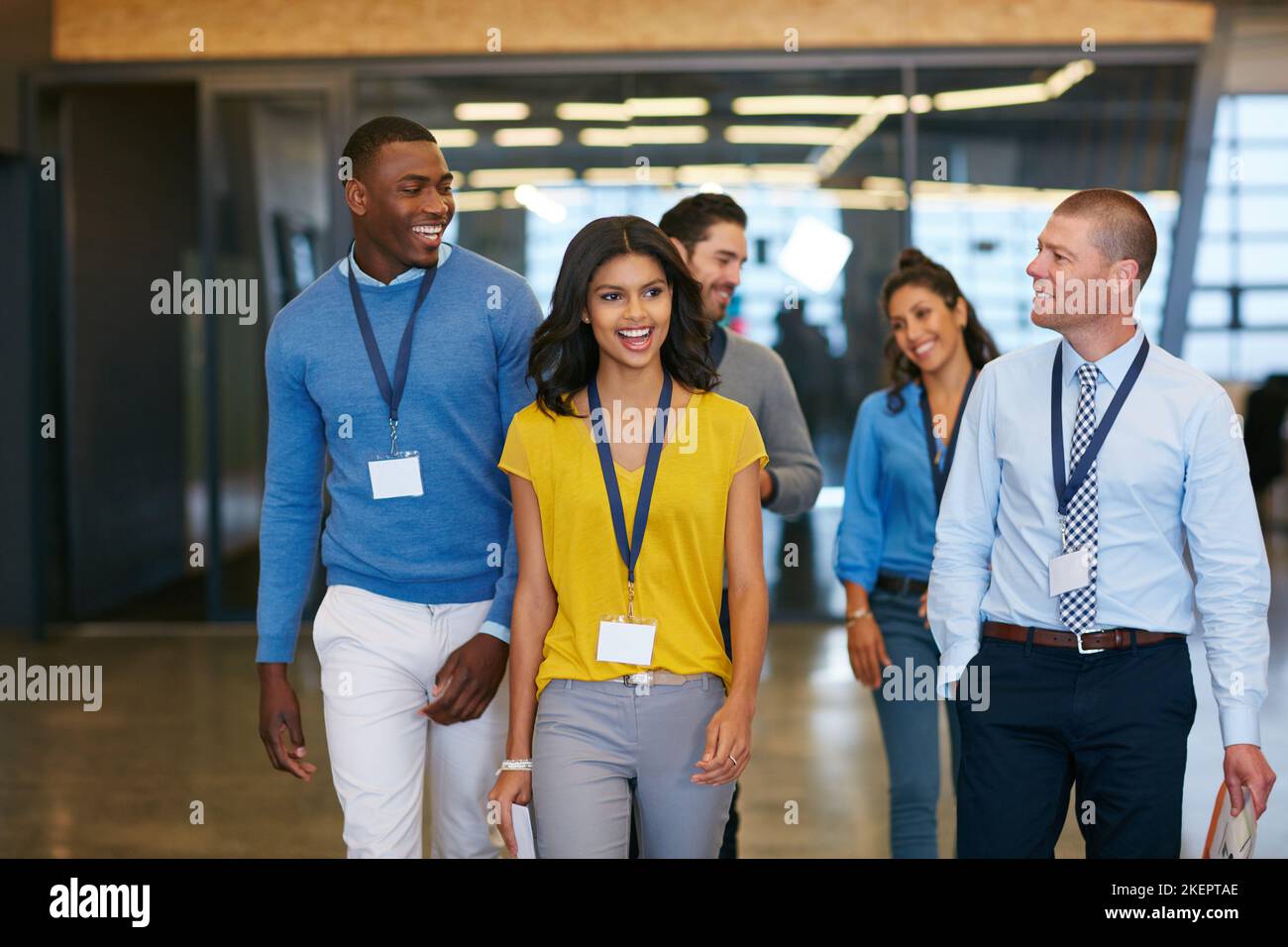 Stepping into the office. a group of businesspeople walking into work ...