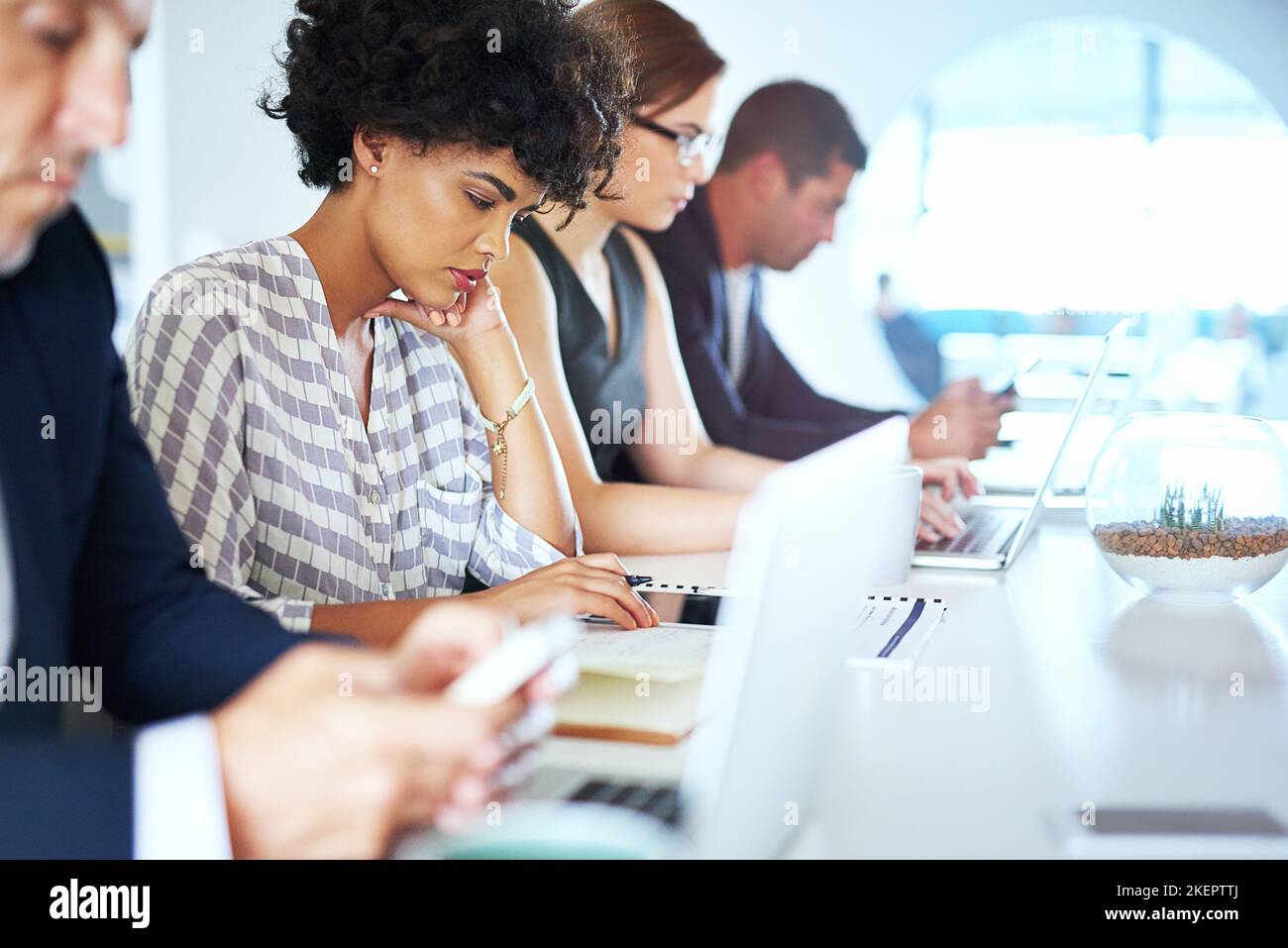 They appreciate the value of hard work. colleagues working at a desk in ...