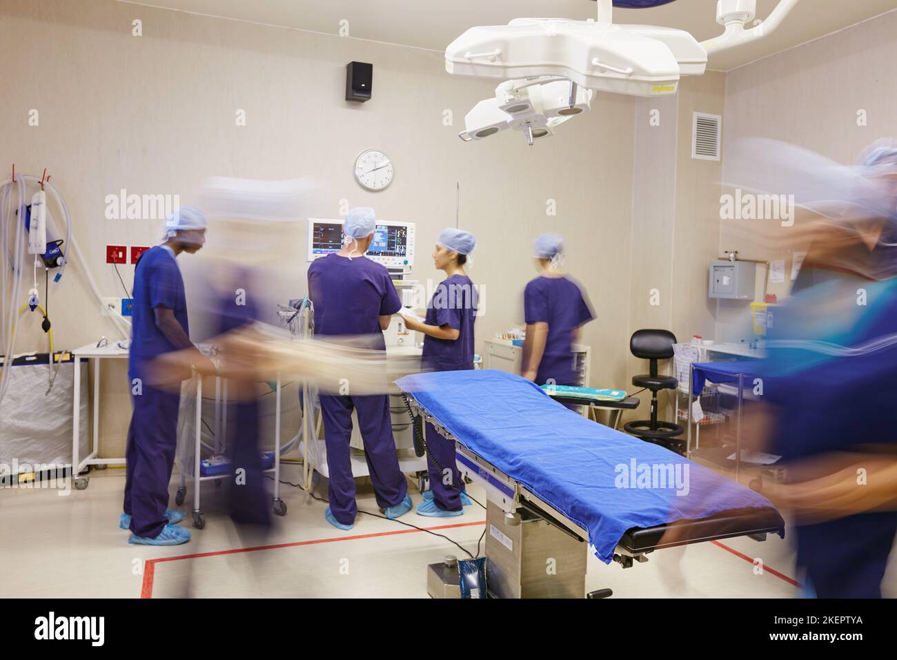 Preparing the ER for the next surgery. a team of surgeons prepping an ...