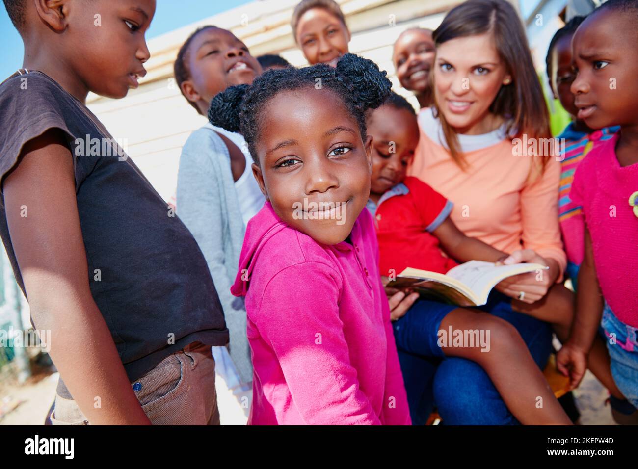 We love story time. a volunteer worker reading to a group of children ...