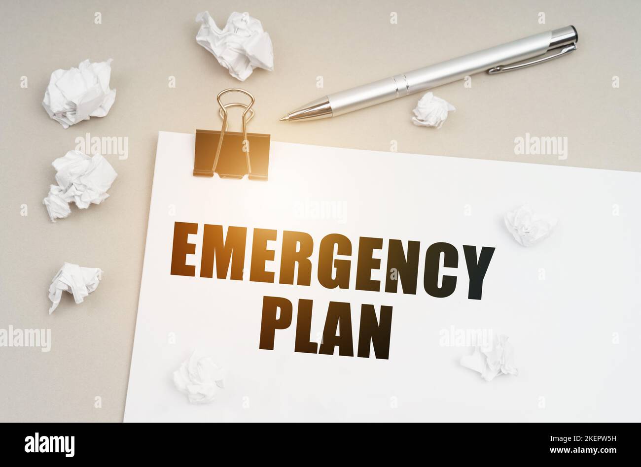 Economy and business concept. On a gray surface, a pen, crumpled paper ...